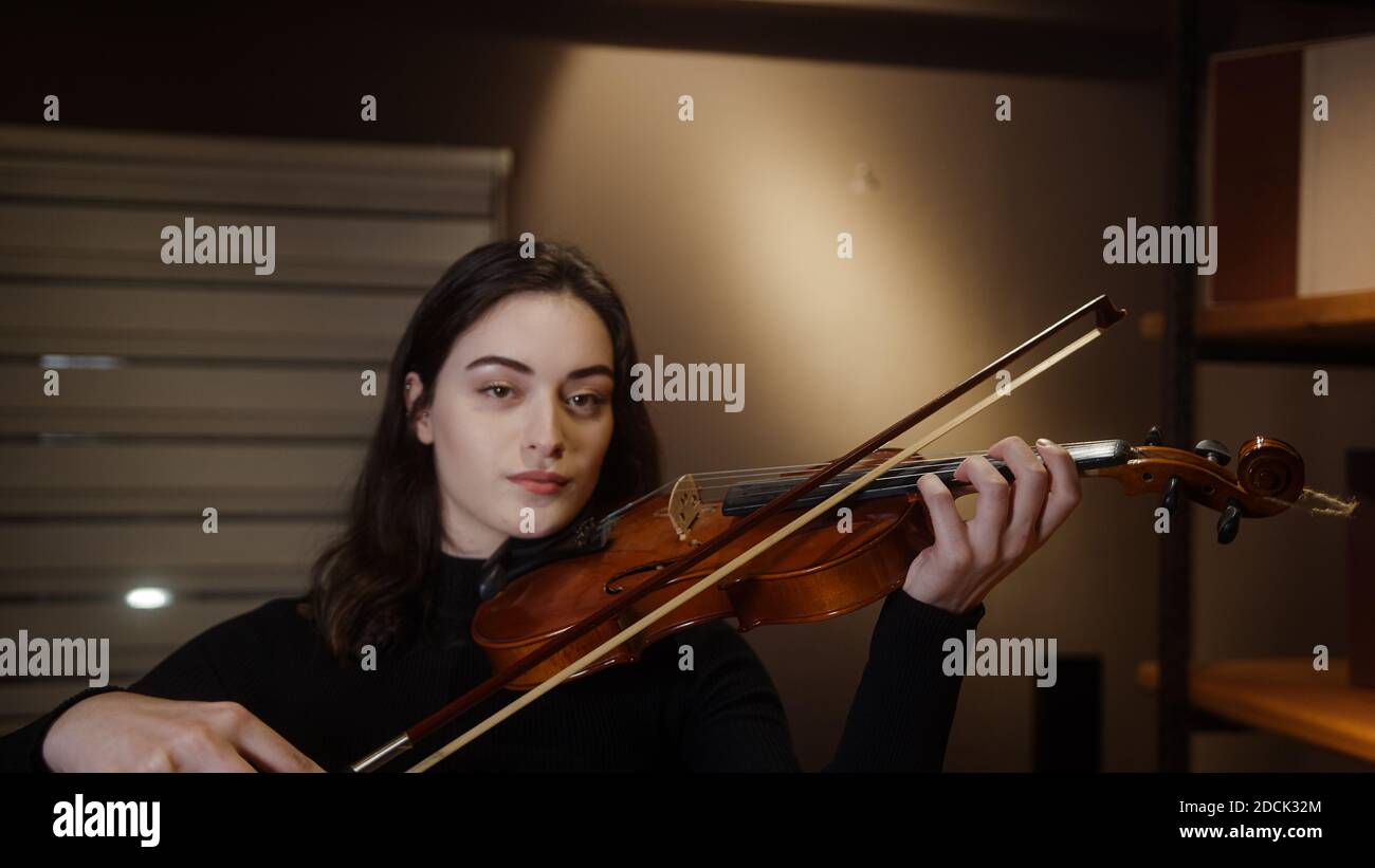 Beautiful and simple wooden violin in the hands of a girl, instrument ...