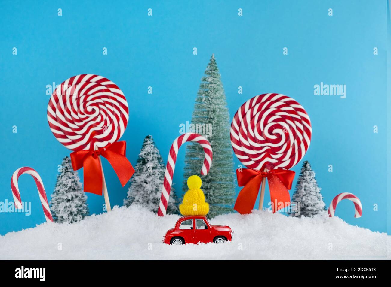Red Santa car with in yellow winter cap and Christmas tree forest with ...