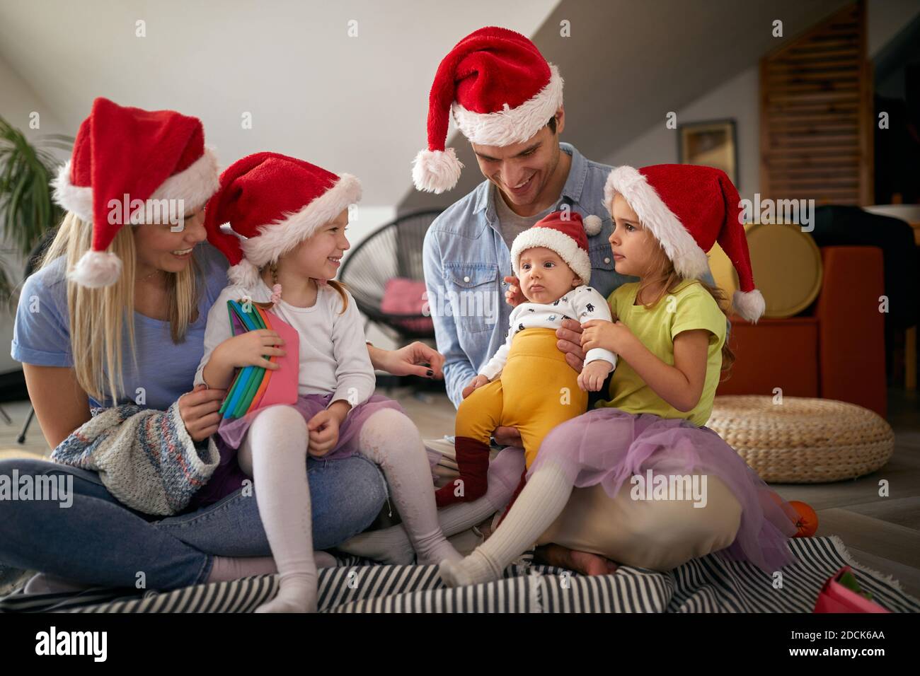 Cheerful parents spening Christmas time together with their kids ...