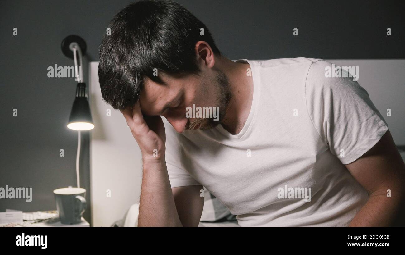 Sick man in bed measuring temperature feeling fever. High temperature ...