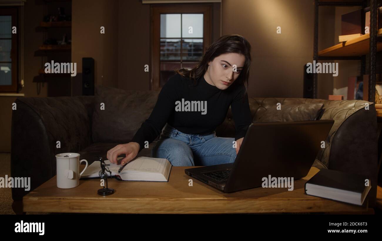 Young college or high school student pretty girl studying at table with ...