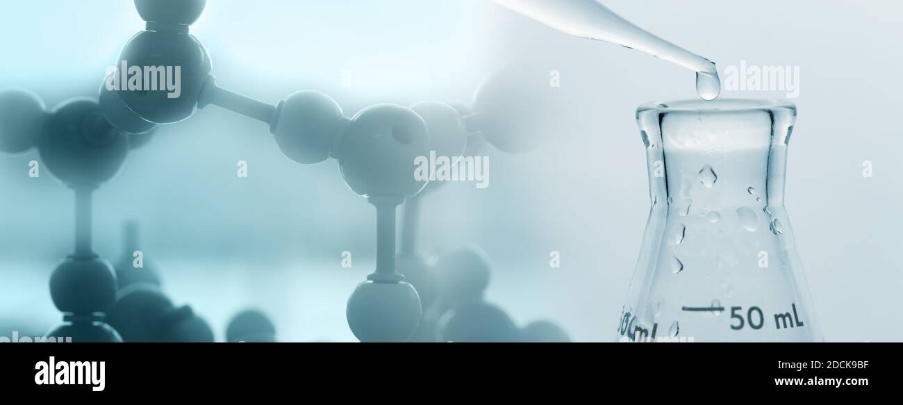 glass dropper with water drop in flask with molecular structure science ...