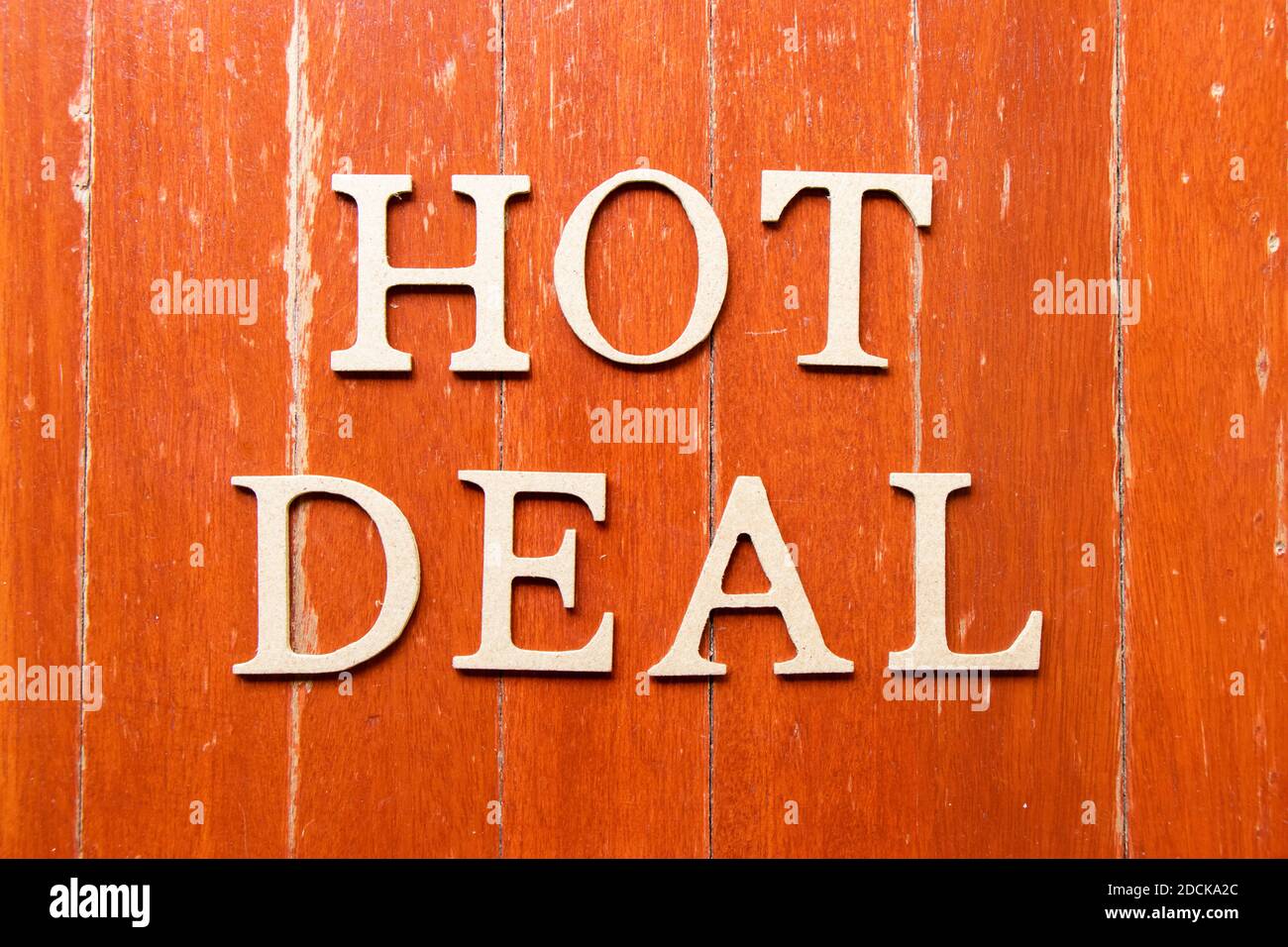 Alphabet letter in word hot deal on old red color wood plate background ...
