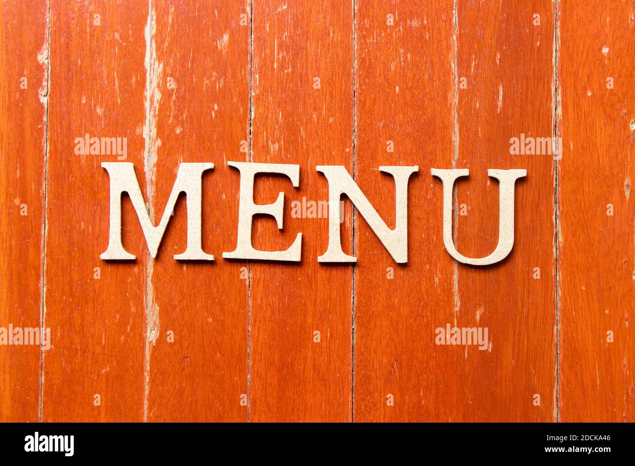 Alphabet letter in word menu on old red color wood plate background ...