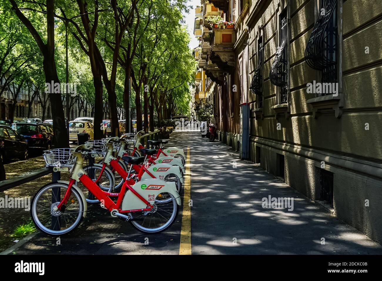 Milan street panorama with Milan trams, pedestrians and cars on a sunny ...