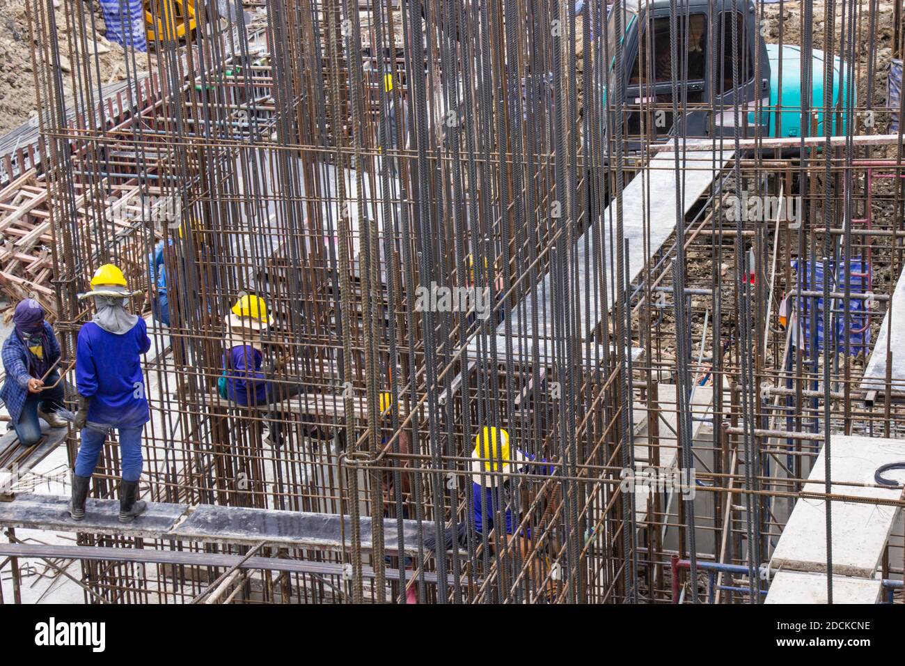 Construction workers fabricating large steel bar reinforcement bar at ...