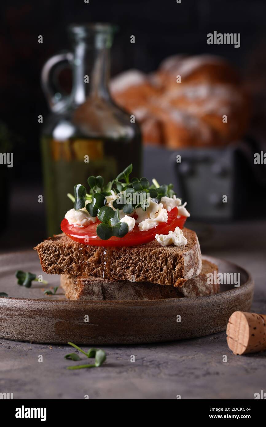 rye bread sandwich with tomatoes and herbs Stock Photo - Alamy