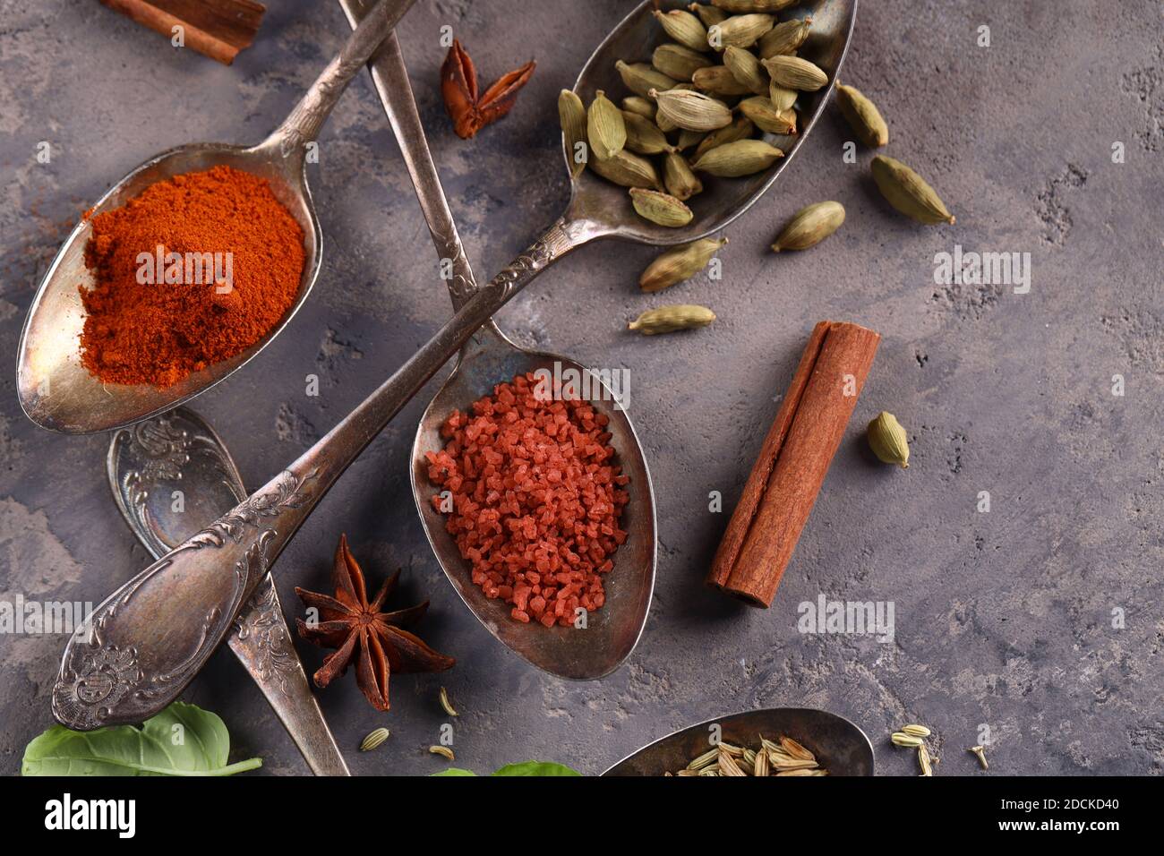 various spices in spoons on a dark background Stock Photo - Alamy