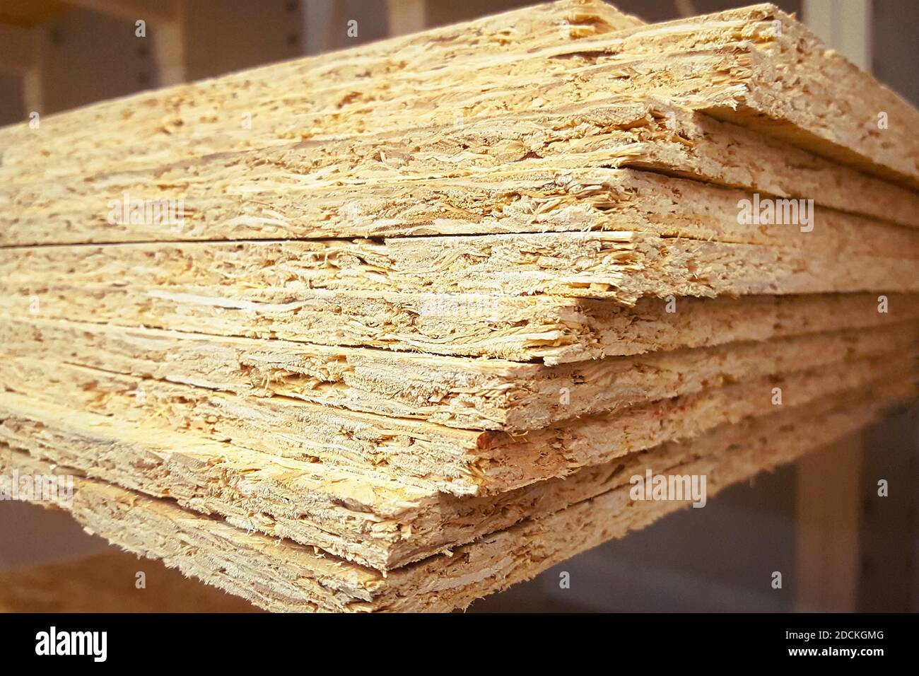 A stack of OSB sheets stacked one on another. Lumber is sold at the ...