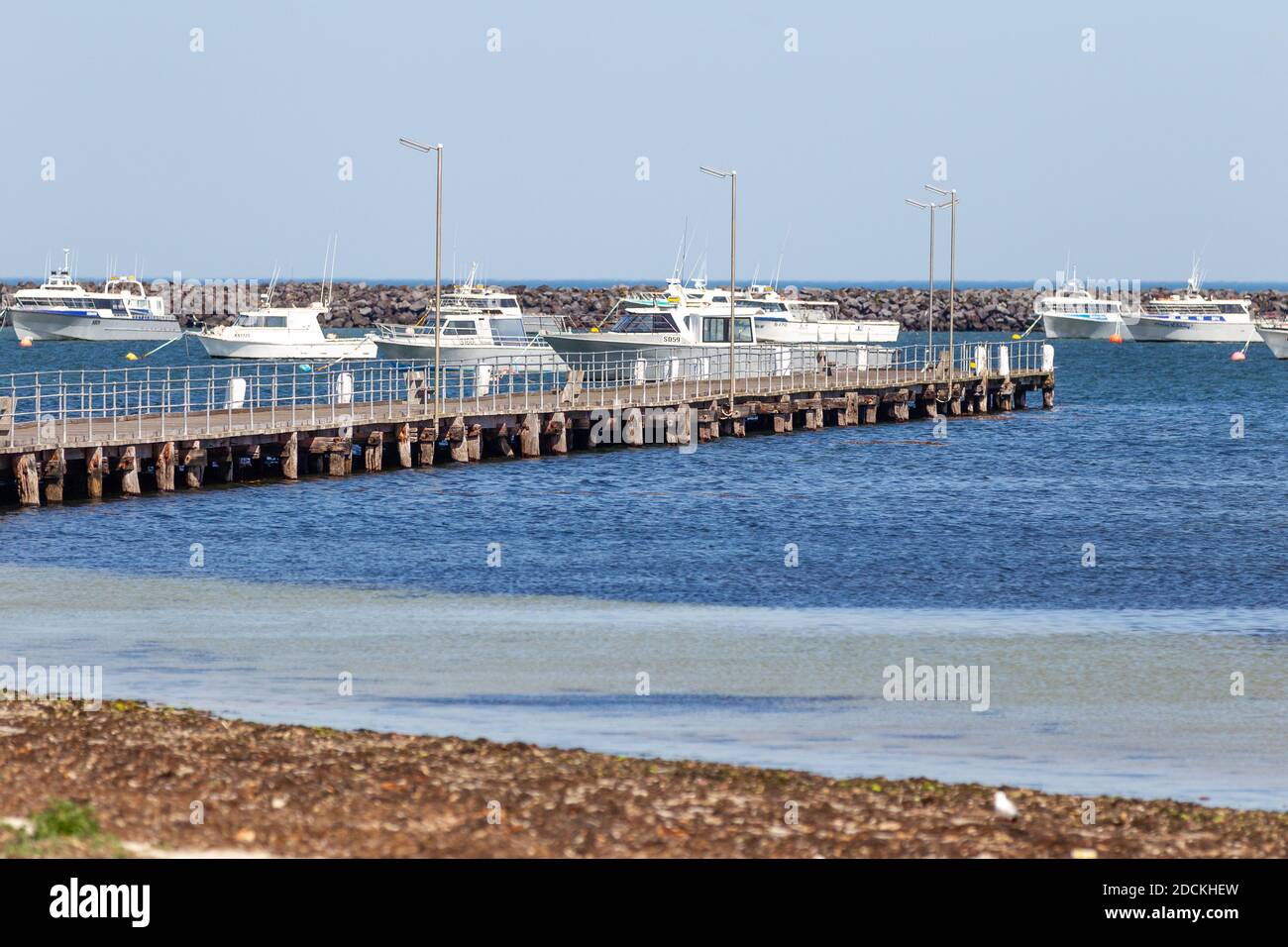 The Port MacDonnell jetty with commercial fishing boats in the ...