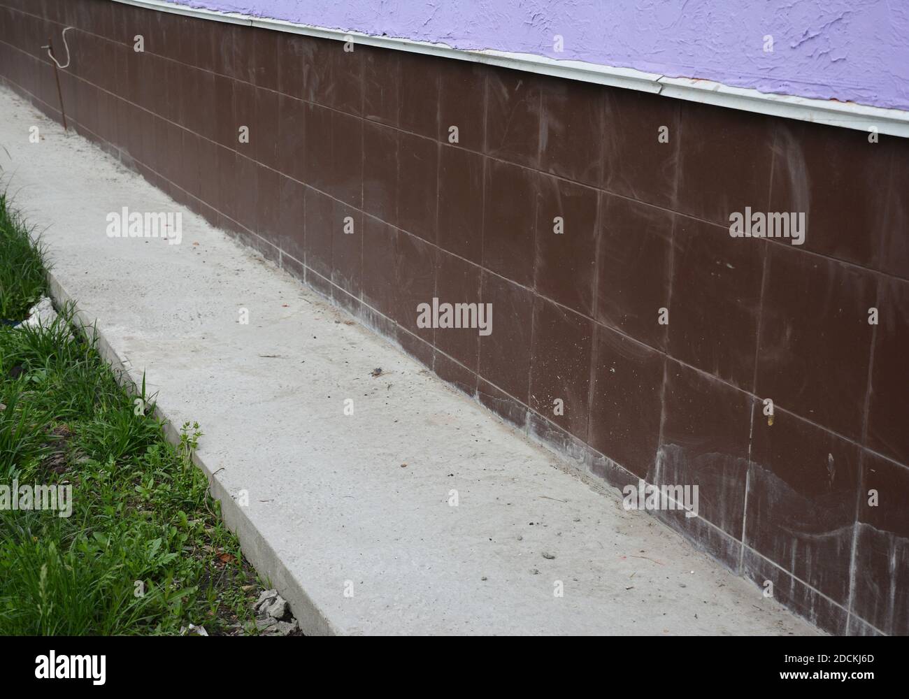 Close up on house exterior tiled foundation waterproofed, damp proofed ...