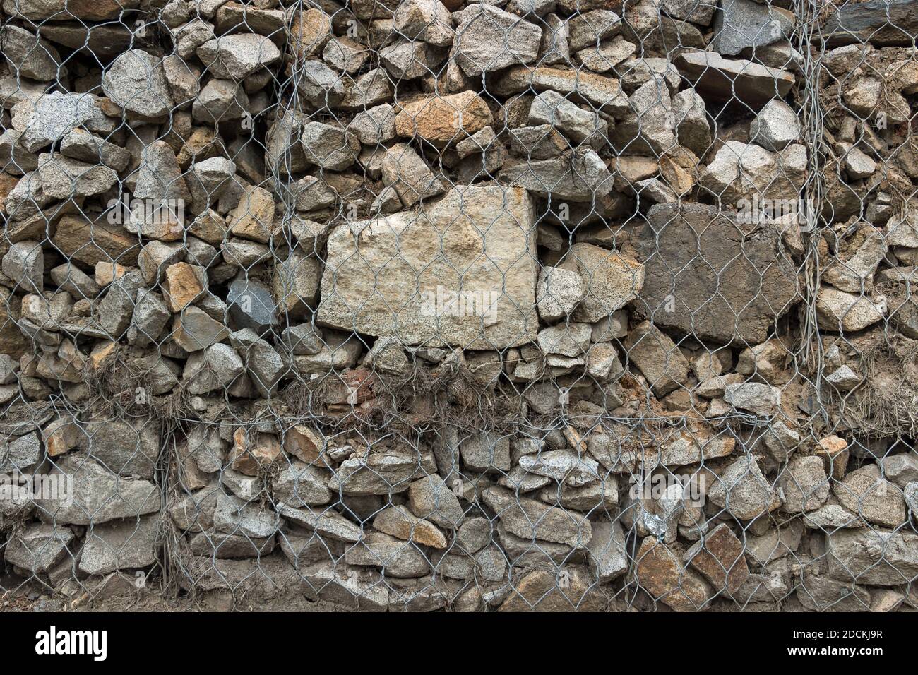 Gabion fence from mesh with stones Stock Photo - Alamy