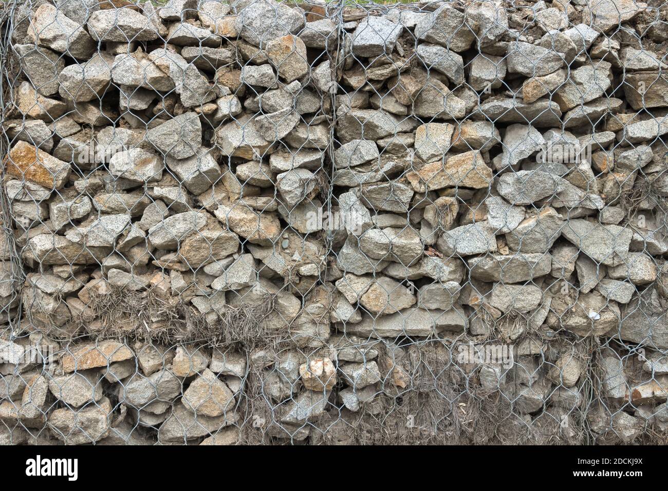 Gabion fence from mesh with stones Stock Photo - Alamy
