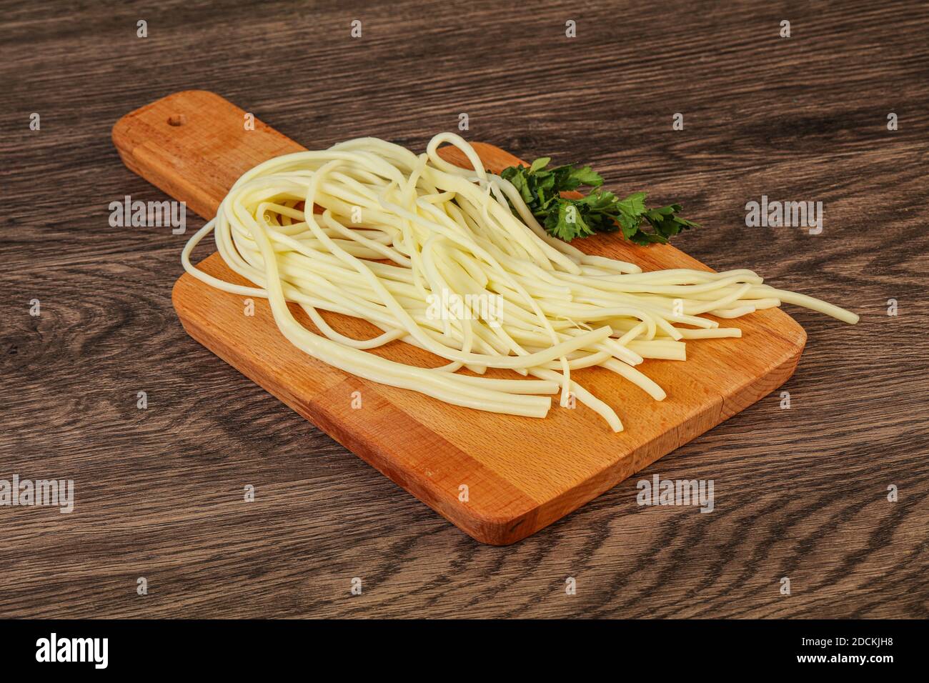 Chechil spaghetti cheese snack over board Stock Photo - Alamy