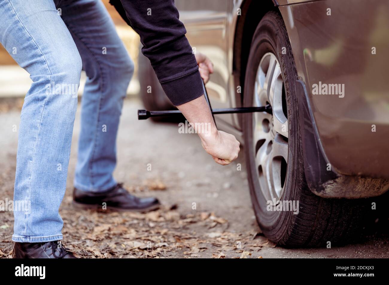 A closeup shot of a man repairing a wheel with a tool Stock Photo - Alamy