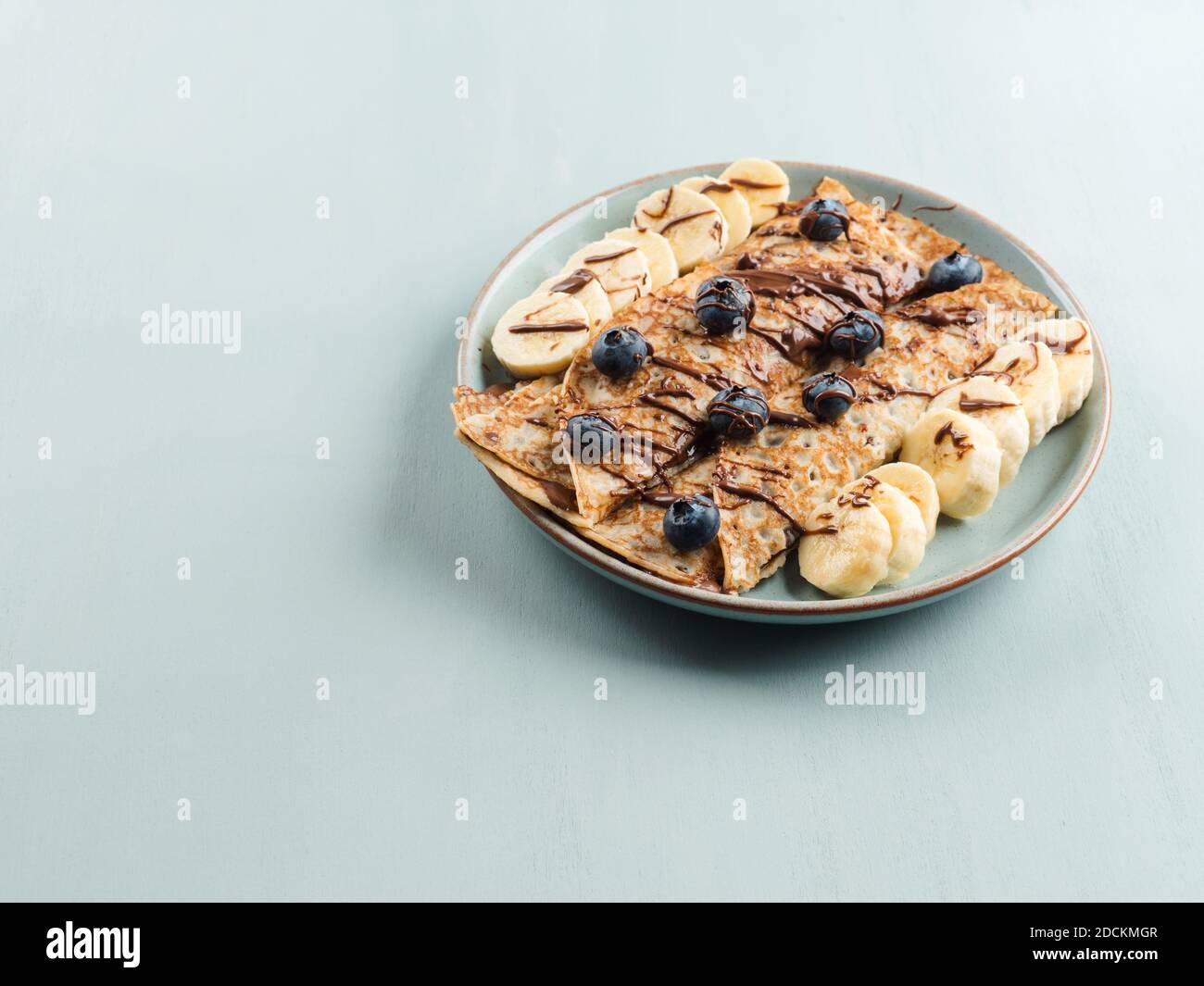 Crepes with chocolate nut spread, banana, berries Stock Photo - Alamy