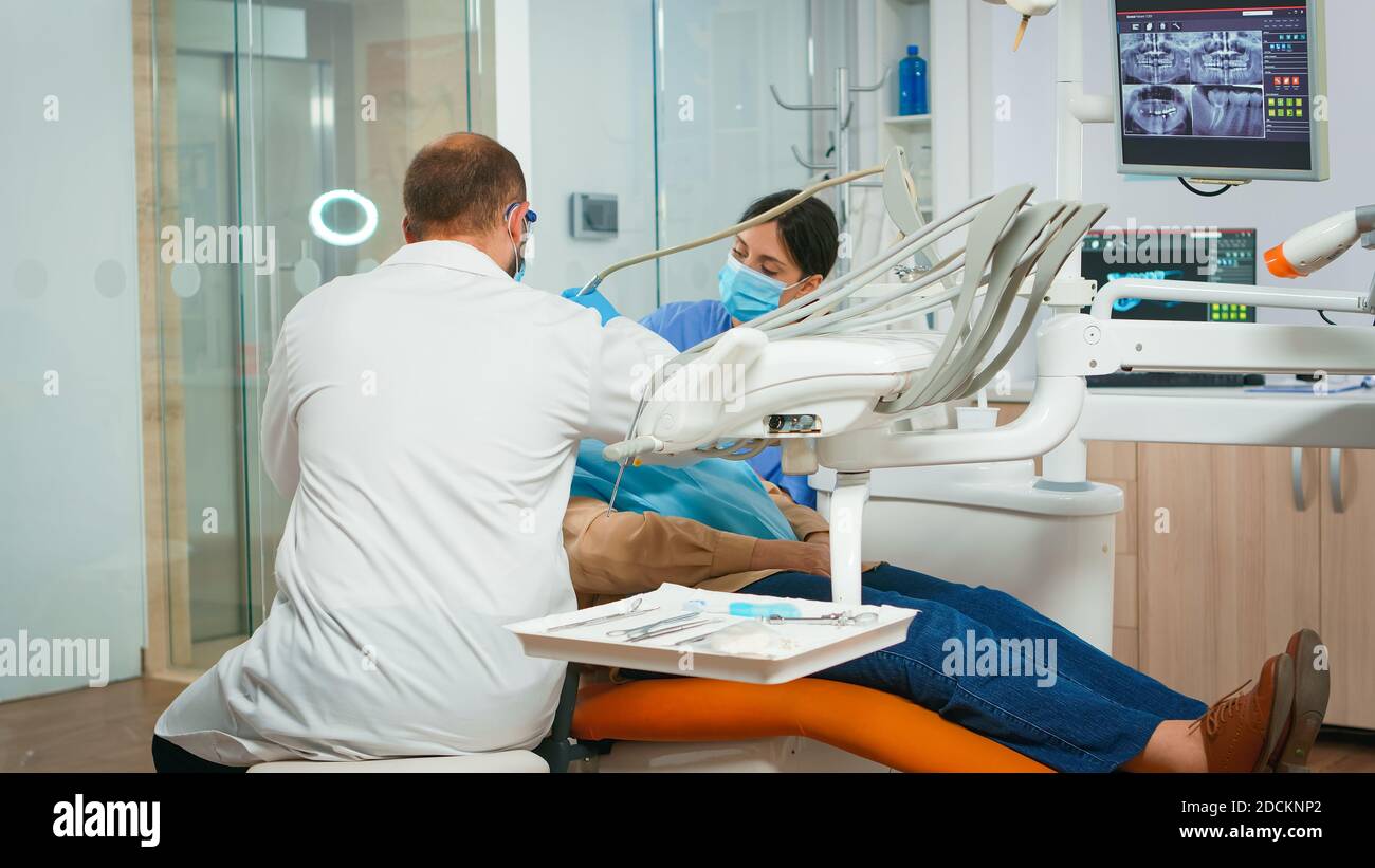 Dentistry doctor doing hygienic cleaning of teeth using sterile dental ...