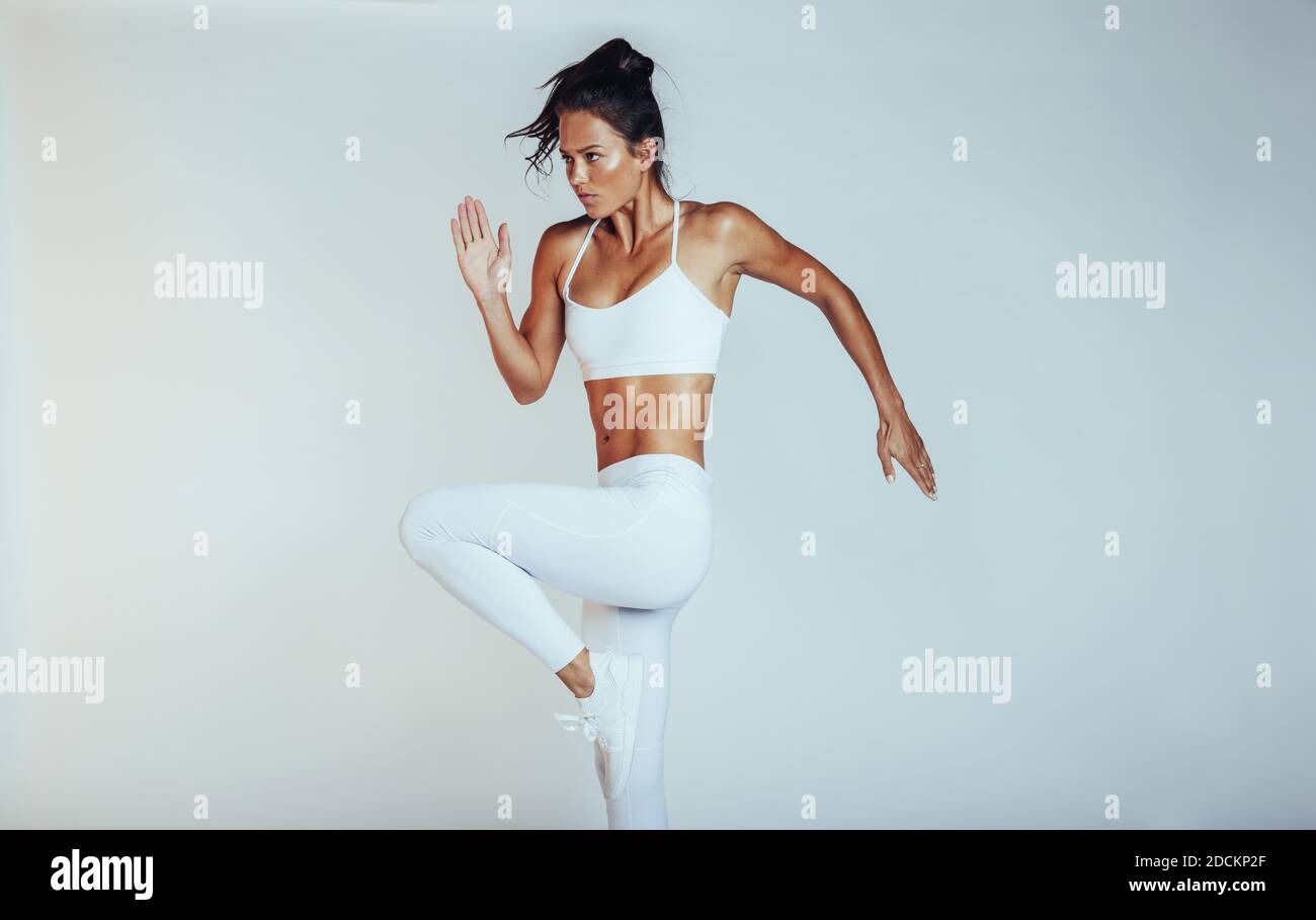 Female runner doing fitness workout. Slim woman athlete exercising on ...