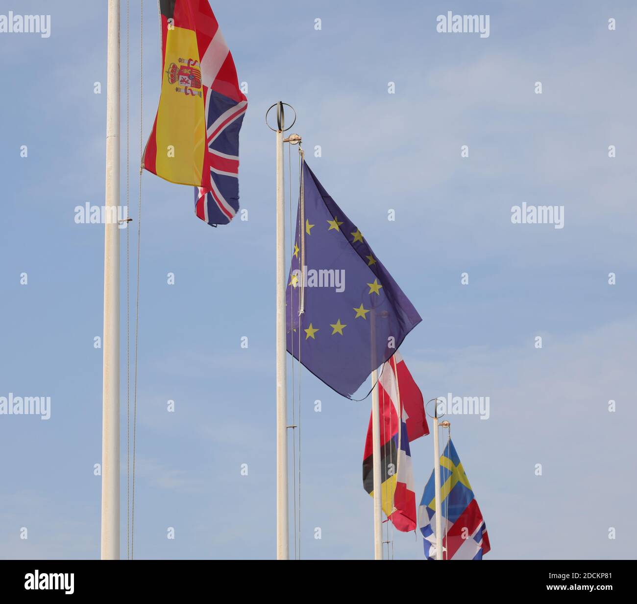 many flags of many nationalities fly high on the flagpole Stock Photo ...