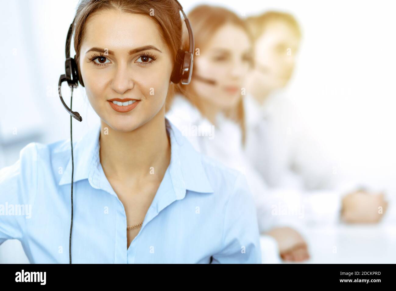 Call center. Focus on beautiful business woman in headset Stock Photo ...