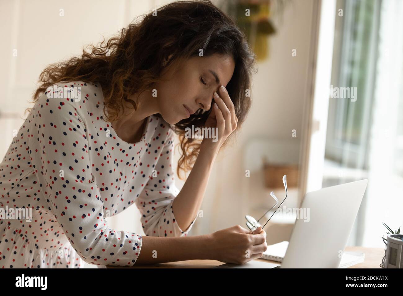 Exhausted woman struggle with headache working on computer Stock Photo ...