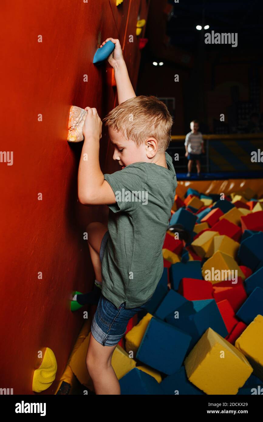 Kid climbing wall inside hi-res stock photography and images - Alamy