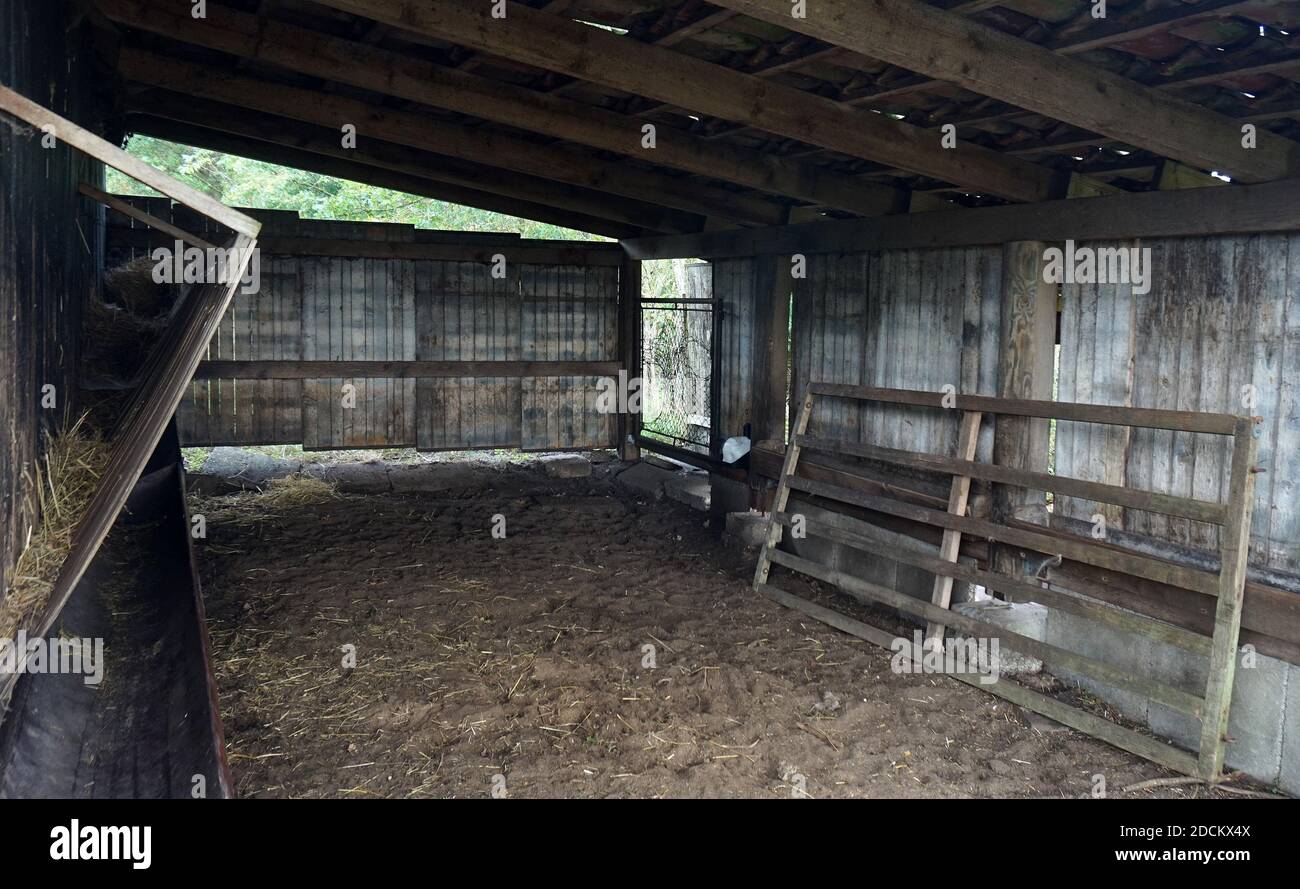 Outer part of a rustic old wooden sheepfold. The back is half open. The ...