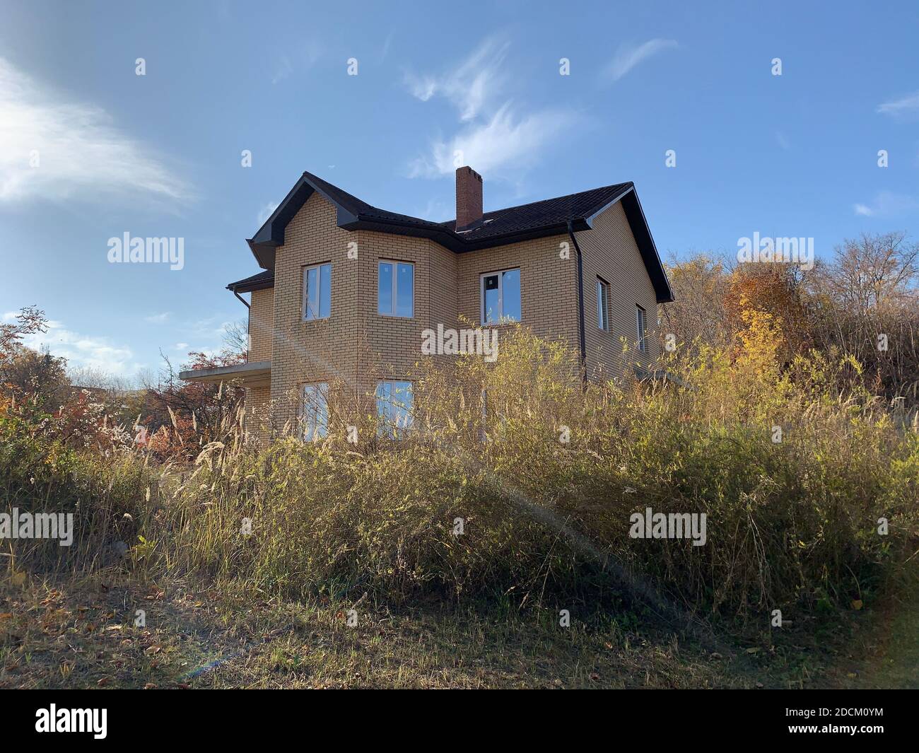 Modern mansion in light colors in autumn Stock Photo - Alamy