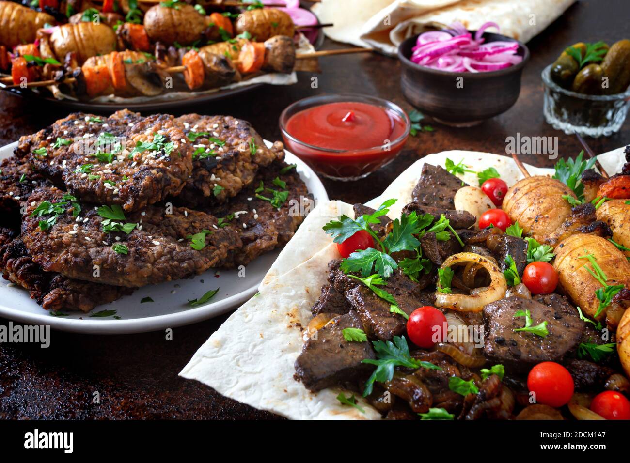 Skewered liver, whole vegetables and mushrooms on skewers. Grill ...