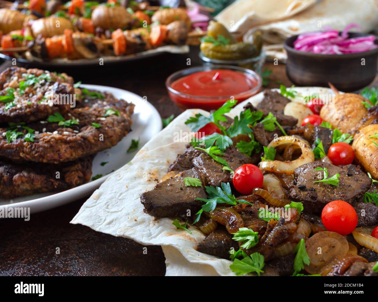 Skewered liver, whole vegetables and mushrooms on skewers. Grill ...