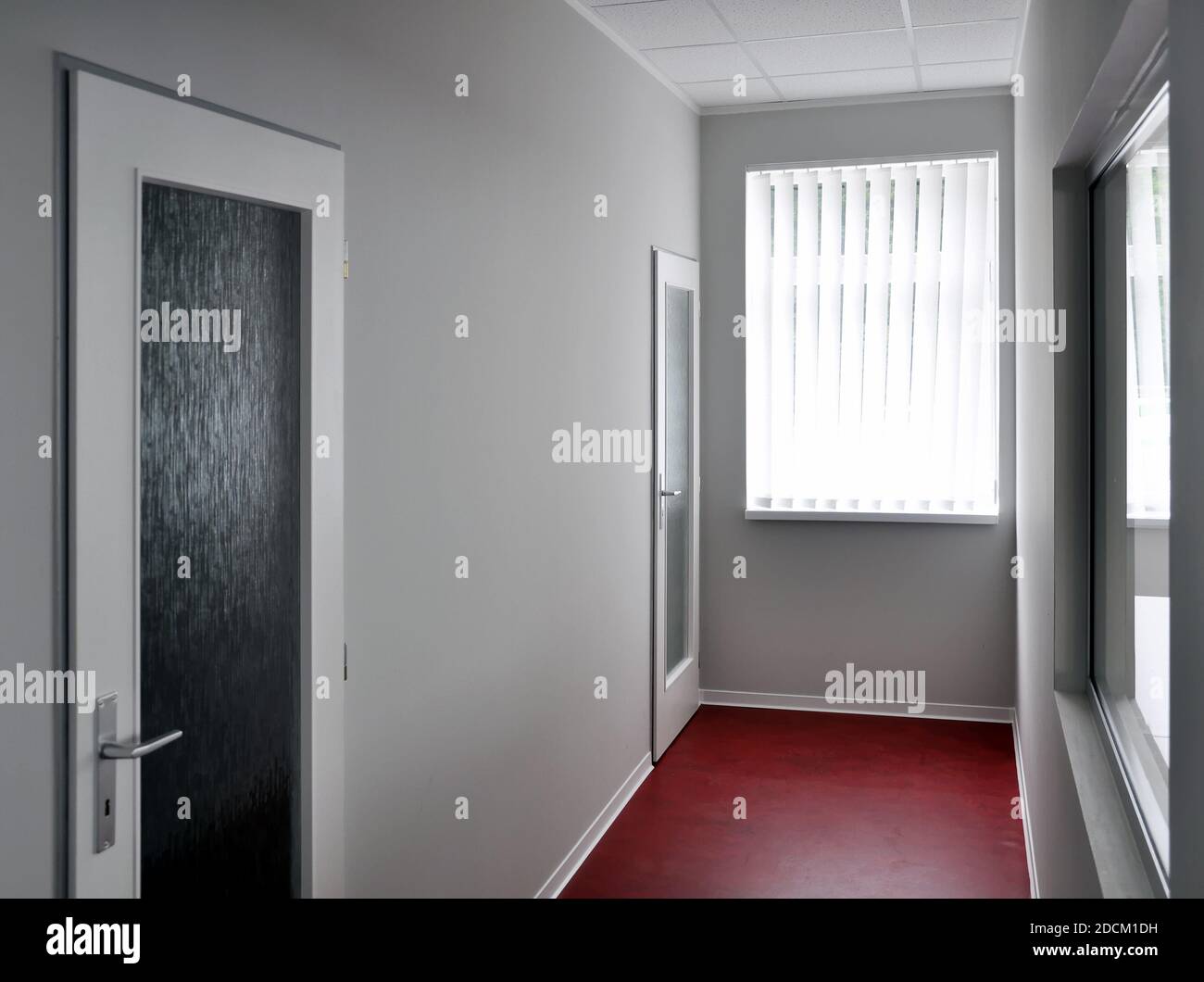 Illuminated corridor of a commercial building Stock Photo - Alamy