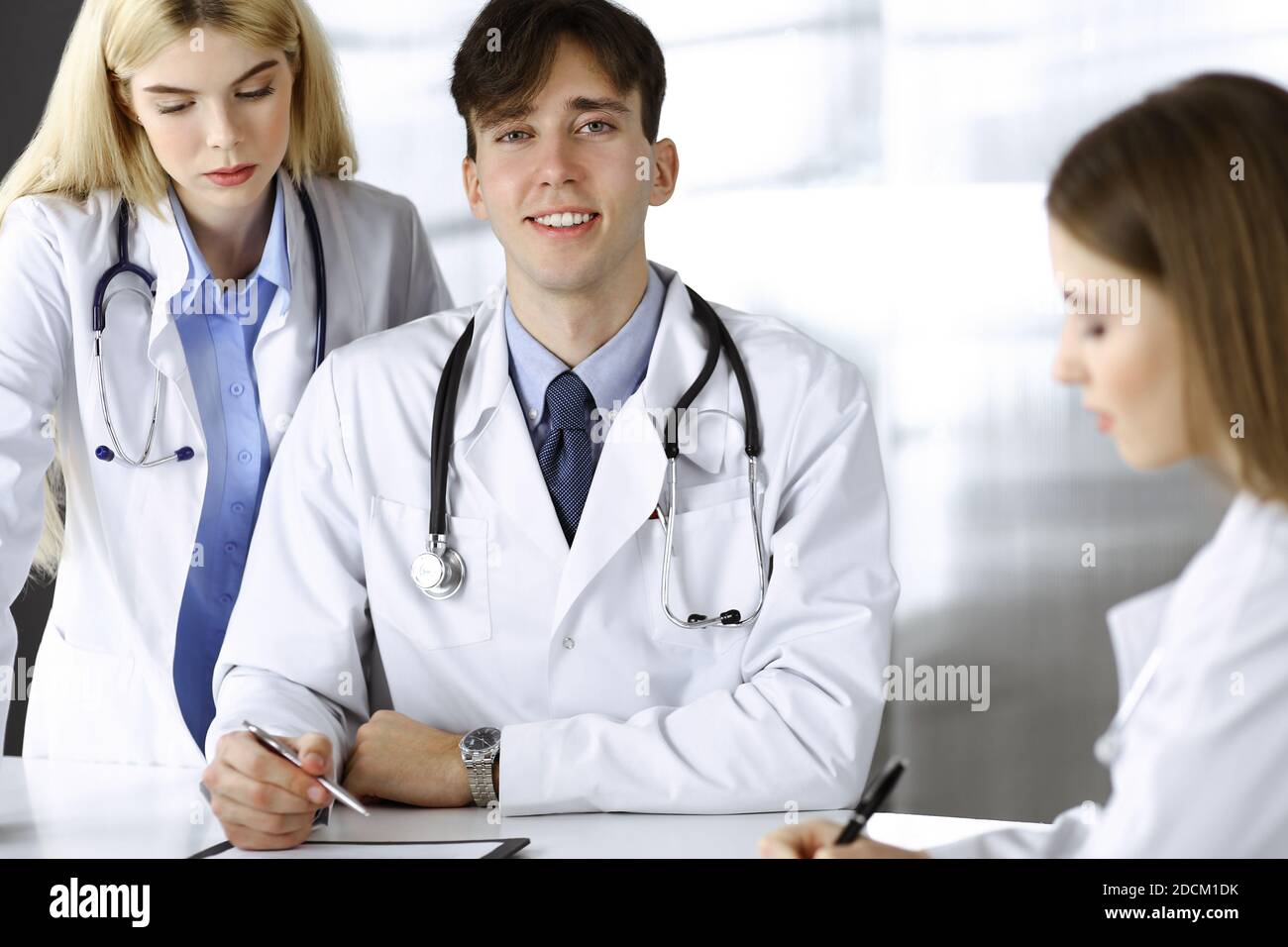 Group of young doctors are discussing disease treatment in modern ...