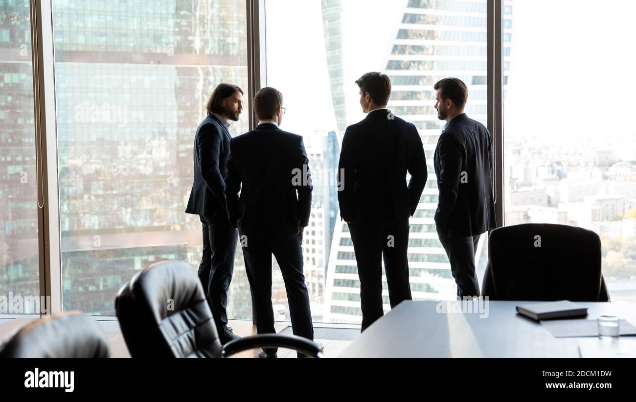 Businessman standing window looking distance hi-res stock photography ...