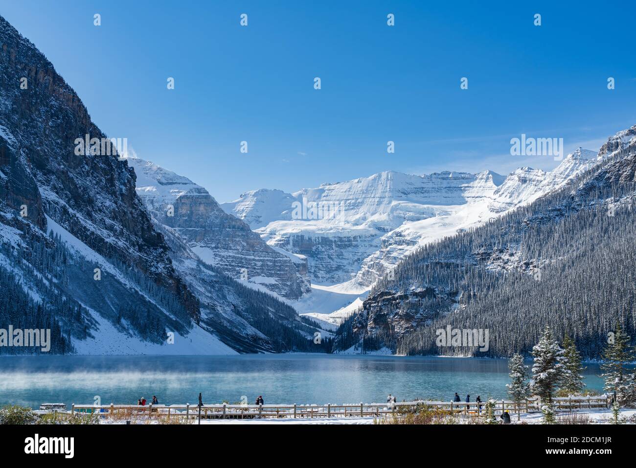 Lake Louise in early winter sunny day morning. Mist floating on ...