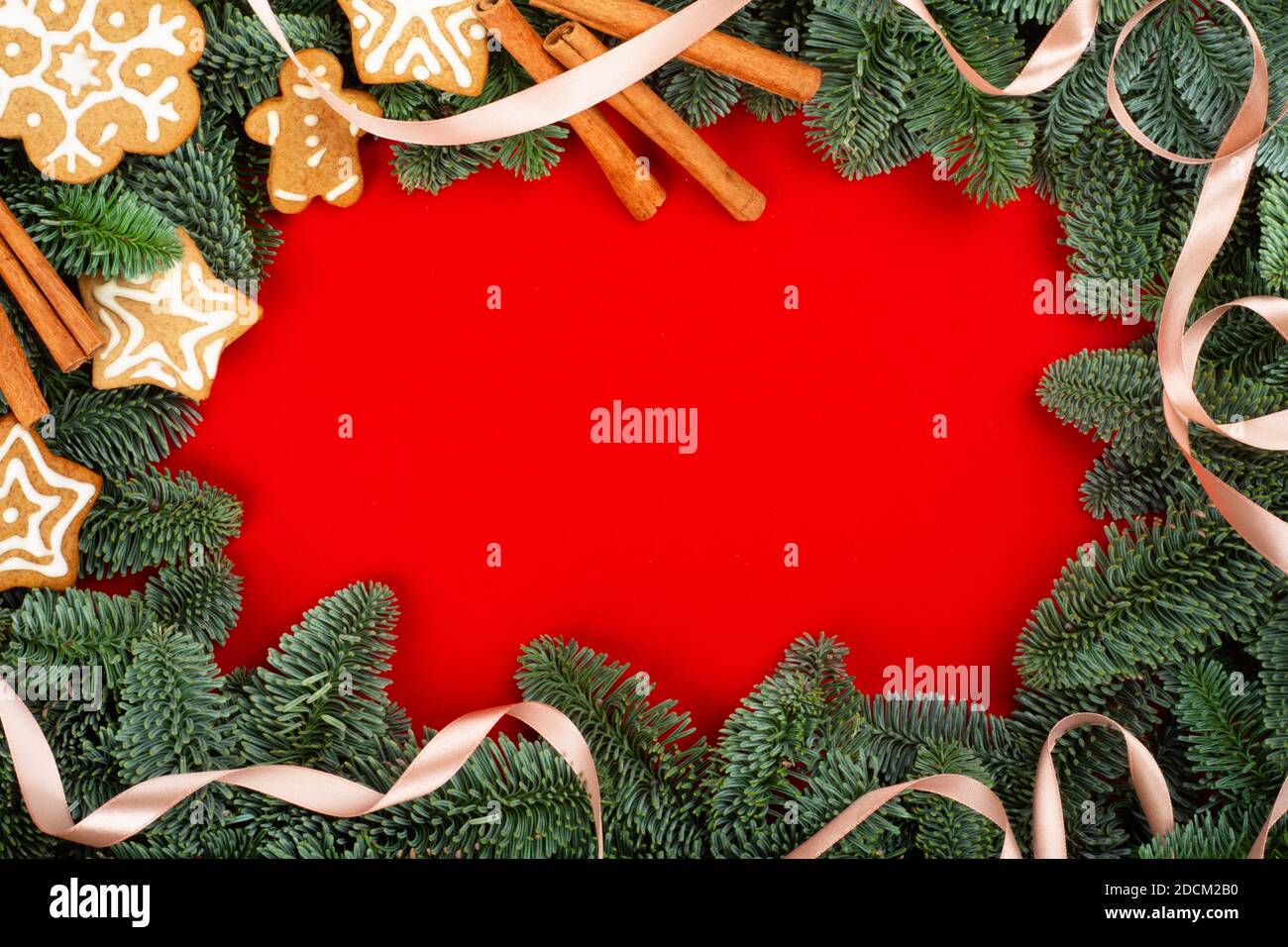 Christmas fir tree branches and food decor border frame on red ...