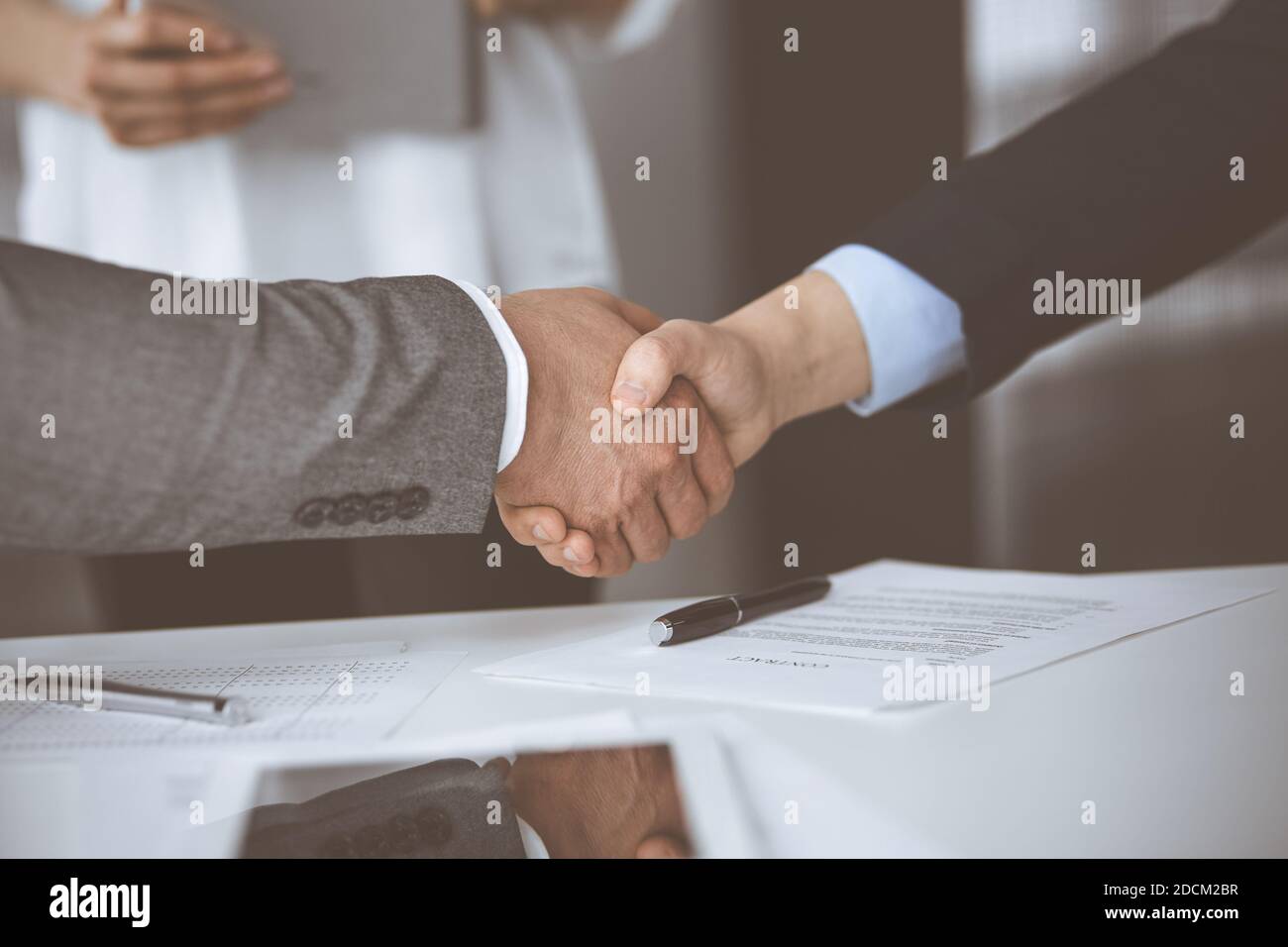 Business people shaking hands finishing contract signing, close-up ...