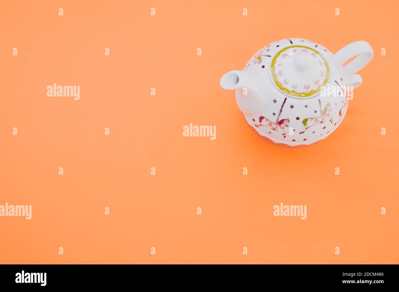 A top view of teapot isolated on an orange background Stock Photo - Alamy