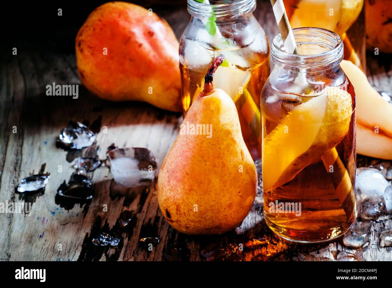 Cold pear juice with a straw, black background, selective focus Stock ...