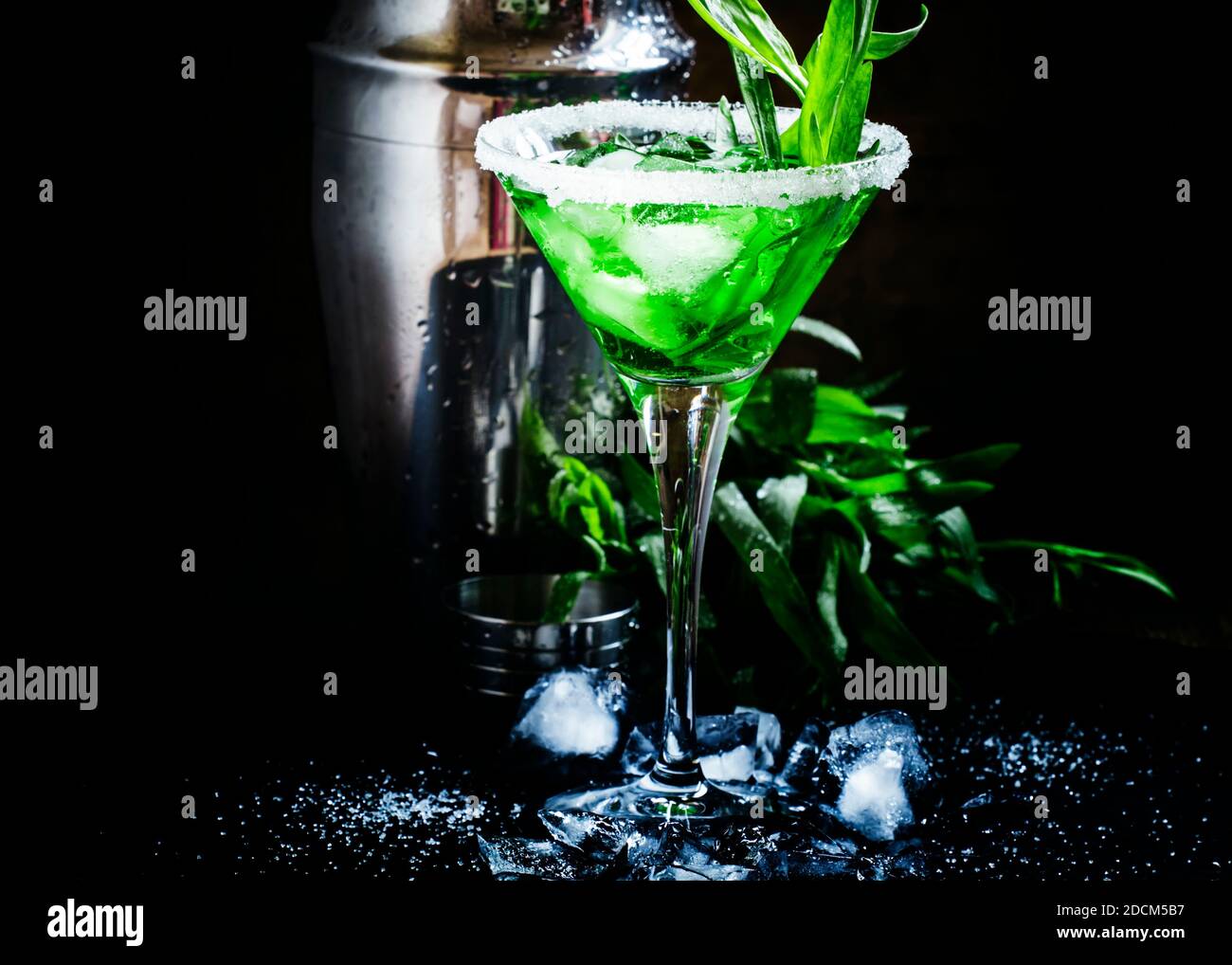 Green alcoholic cocktail with ice in a martini glass decorated with ...