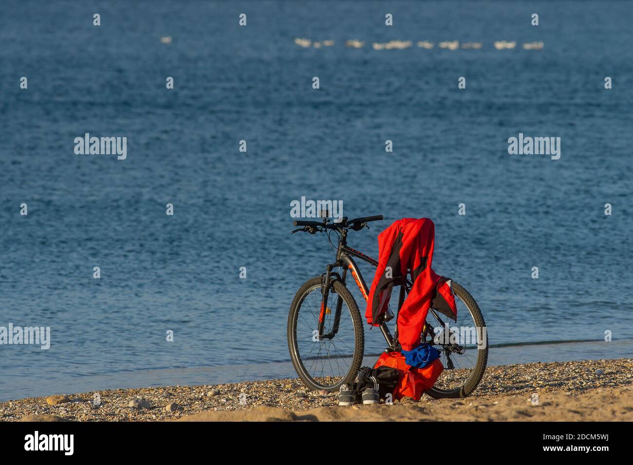 A biker went to swim and left his bike Stock Photo - Alamy
