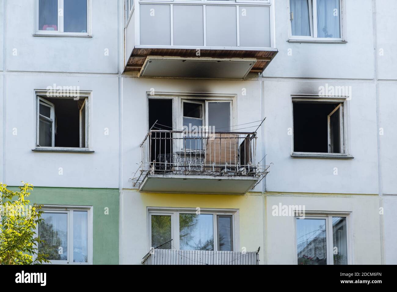Fire in a residential, apartment building. Opened, broken windows of a ...