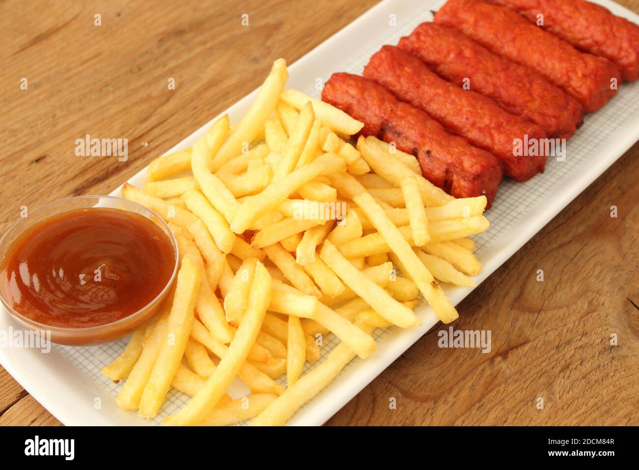 delicious french fries with cevapcici rolls and dip Stock Photo - Alamy