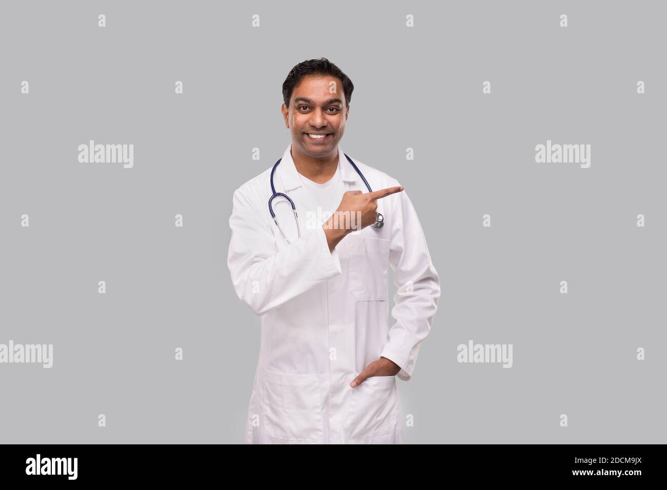 Doctor Pointing to Side and Watching Front. Isolated Stock Photo - Alamy