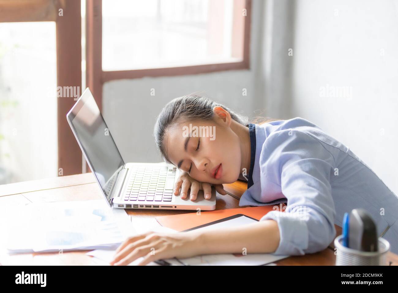 Asia business women feeling sleepy after long time working at the ...