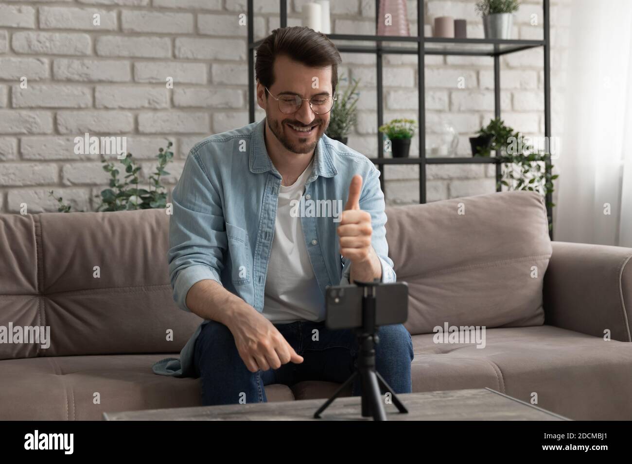 Smiling guy recording vlog mobile hi-res stock photography and images ...