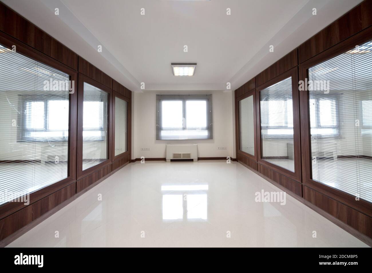 Interior of empty office room with window with white walls and wooden ...
