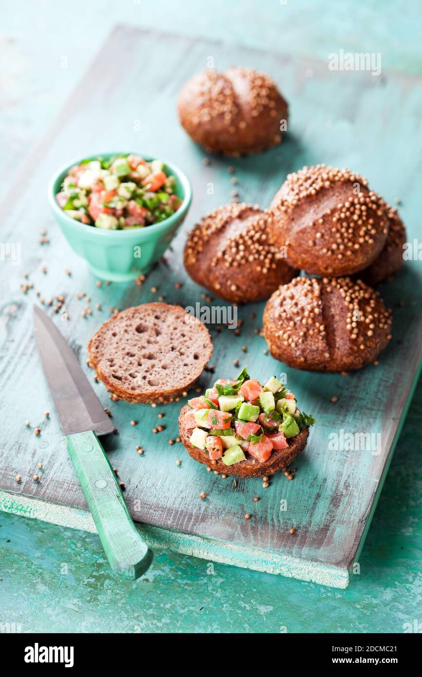 Rye sandwich buns with salmon and avocado tartare, selective focus ...