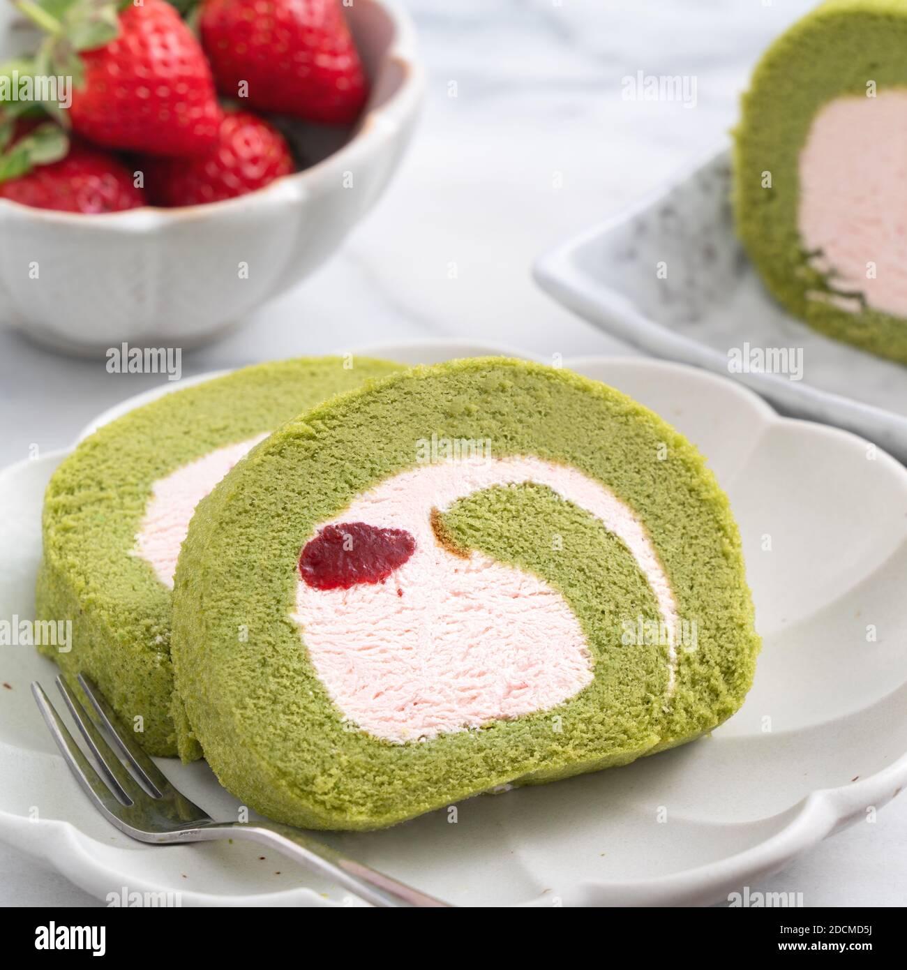 Delicious Matcha Swiss Roll Cake slices with strawberry icing cream on ...