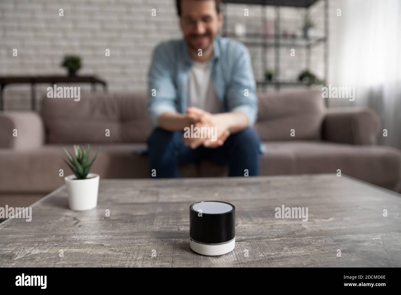 Happy young man looking at small digital portable assistant Stock Photo ...