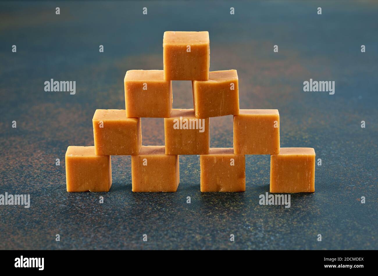 caramel candies on deep blue background Stock Photo - Alamy